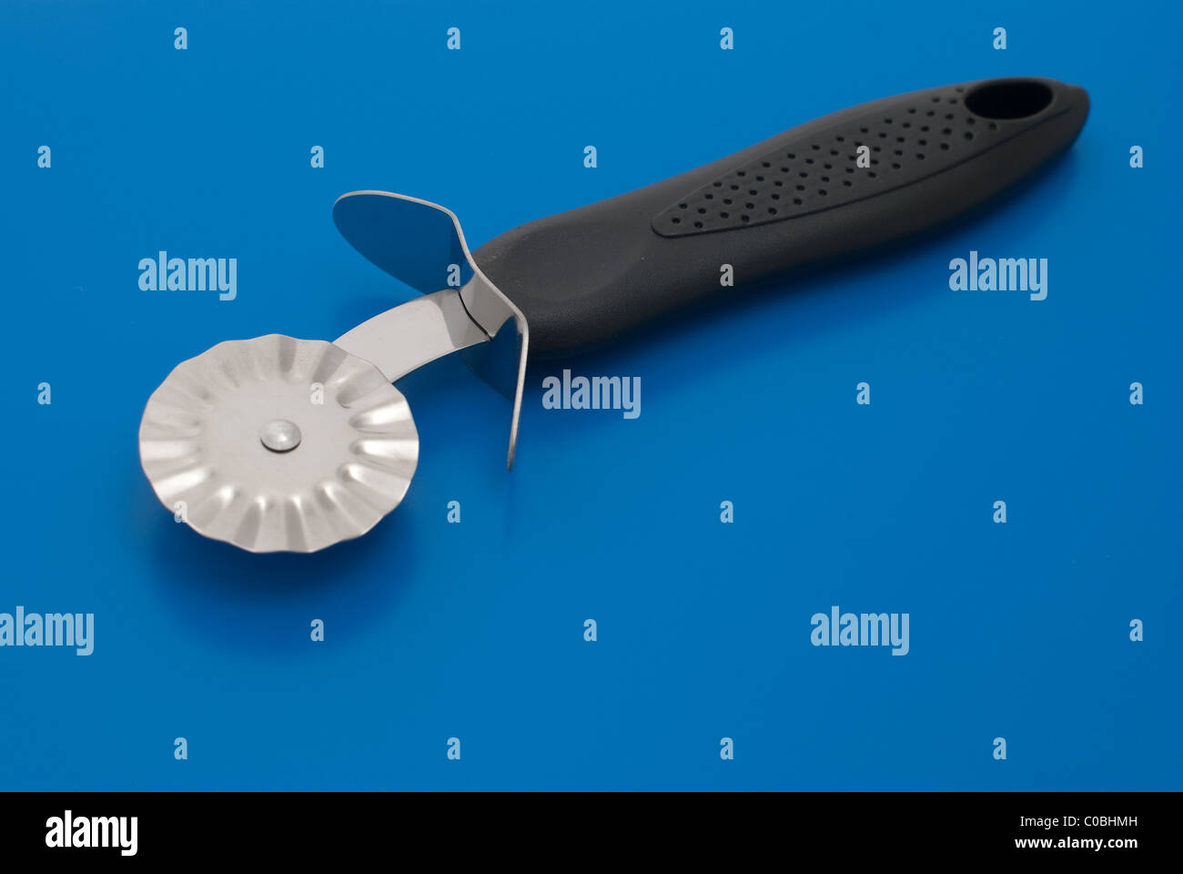 Pie knife isolated on the blue background Stock Photo - Alamy