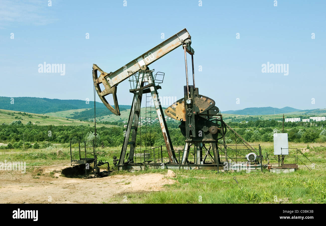 an oil pump is on a background mountains Stock Photo - Alamy