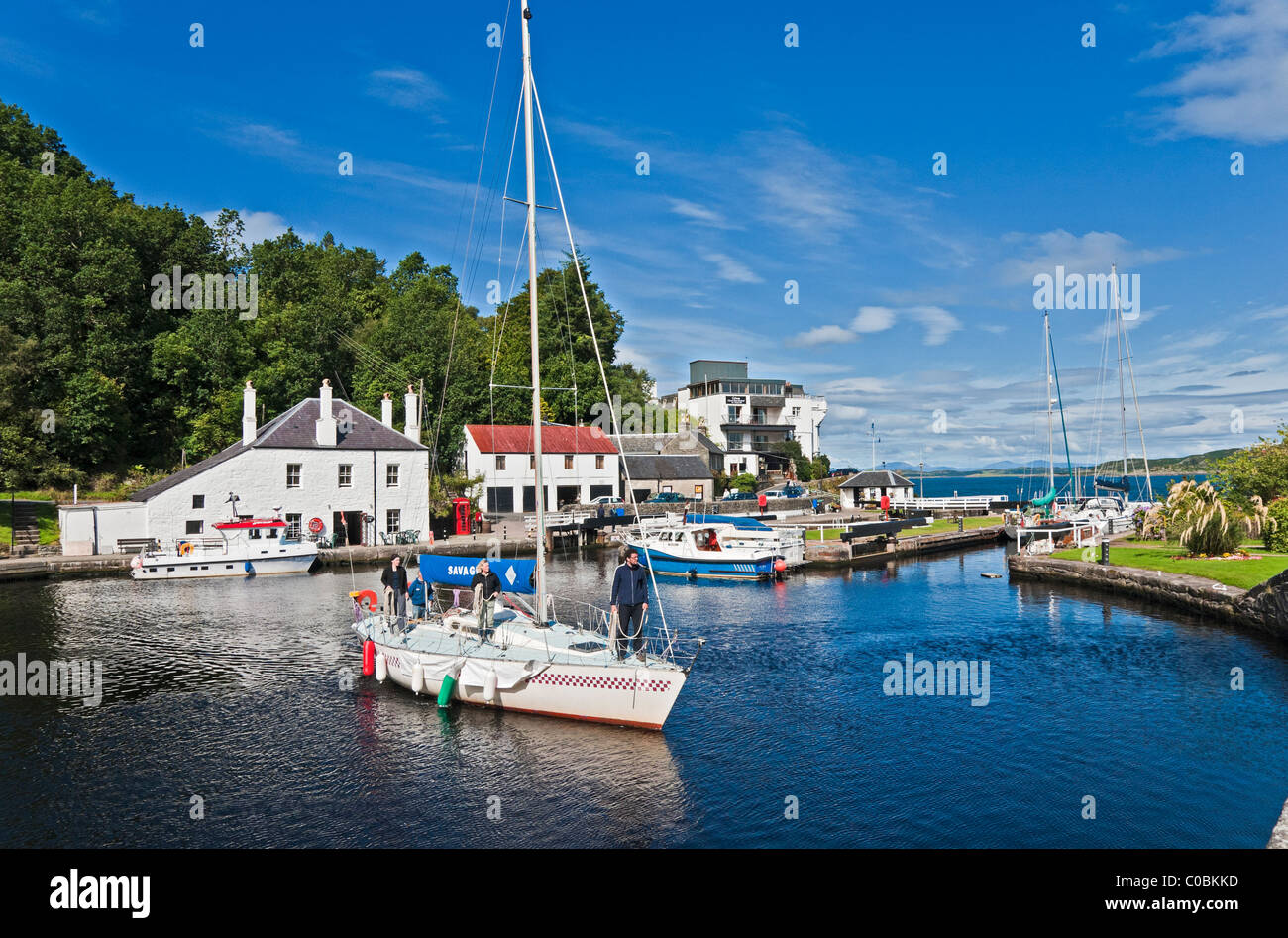 A yacht has entered the Crinan Canal basin at Crinan in Knapdale Argyll ...