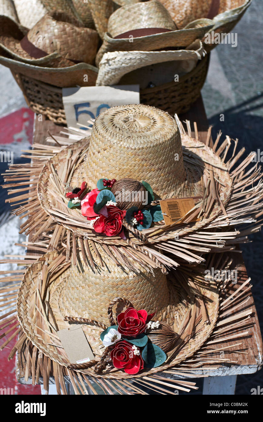 Tattered Straw hats and embellishments for sale on a Thai stall ...