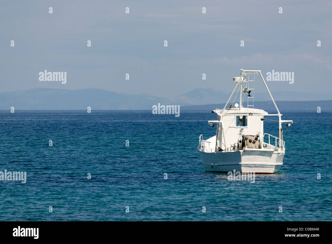 Small white fishing boat at the sea Stock Photo - Alamy