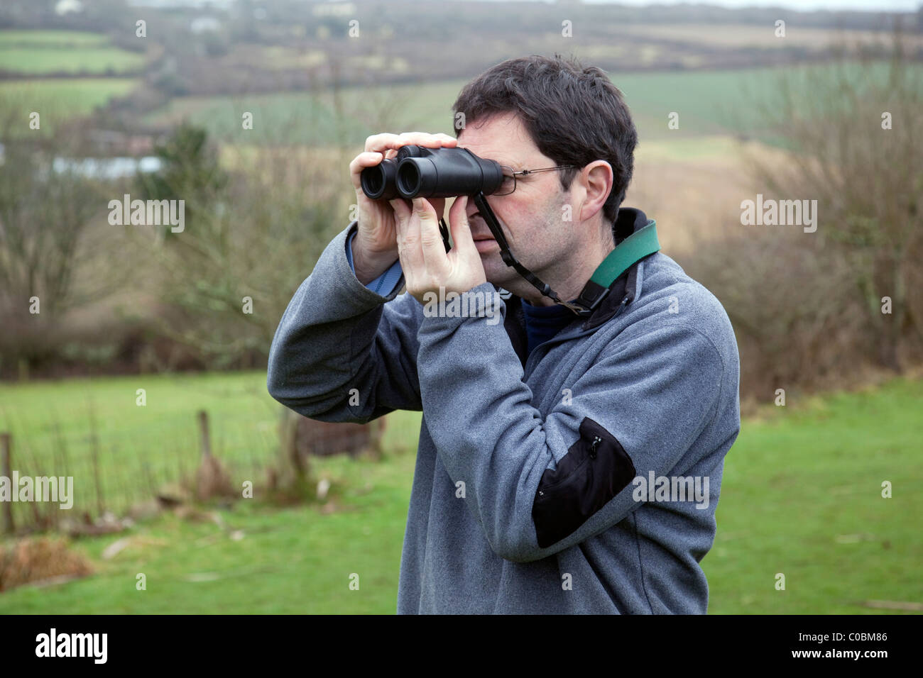 Using binoculars; bird watching; male Stock Photo - Alamy