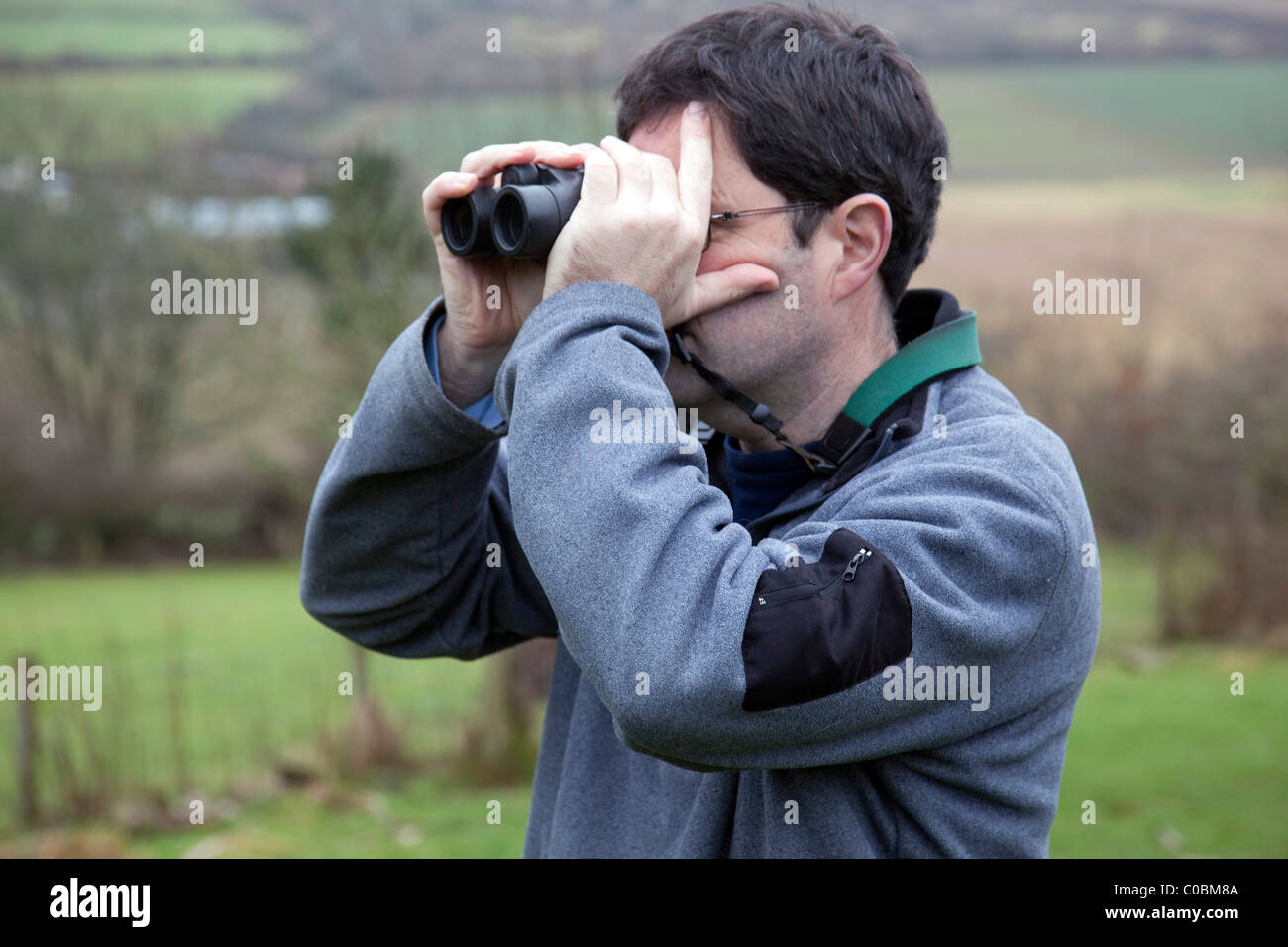 Using binoculars; bird watching; male Stock Photo - Alamy