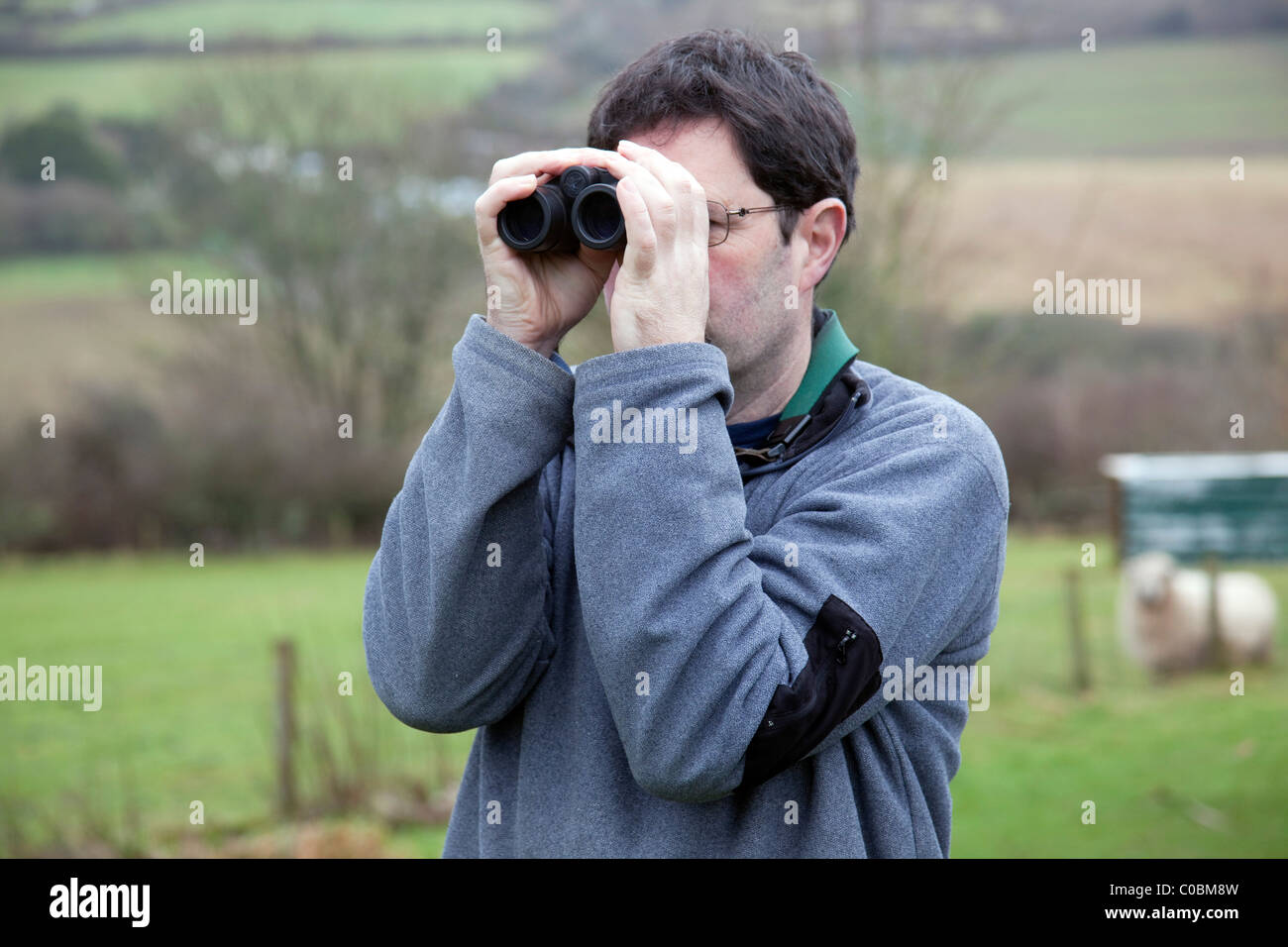 Using binoculars; bird watching; male Stock Photo - Alamy