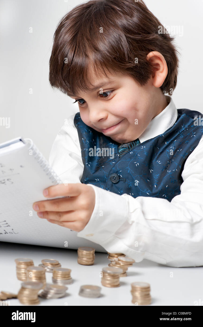 Child counting money and taking notes Stock Photo - Alamy