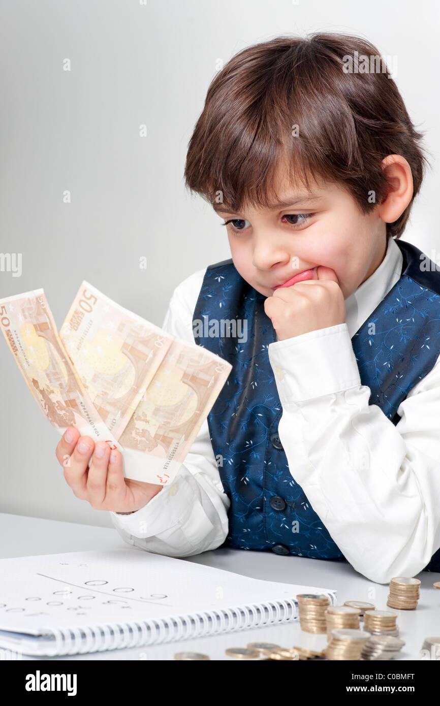 Child counting money and taking notes Stock Photo - Alamy