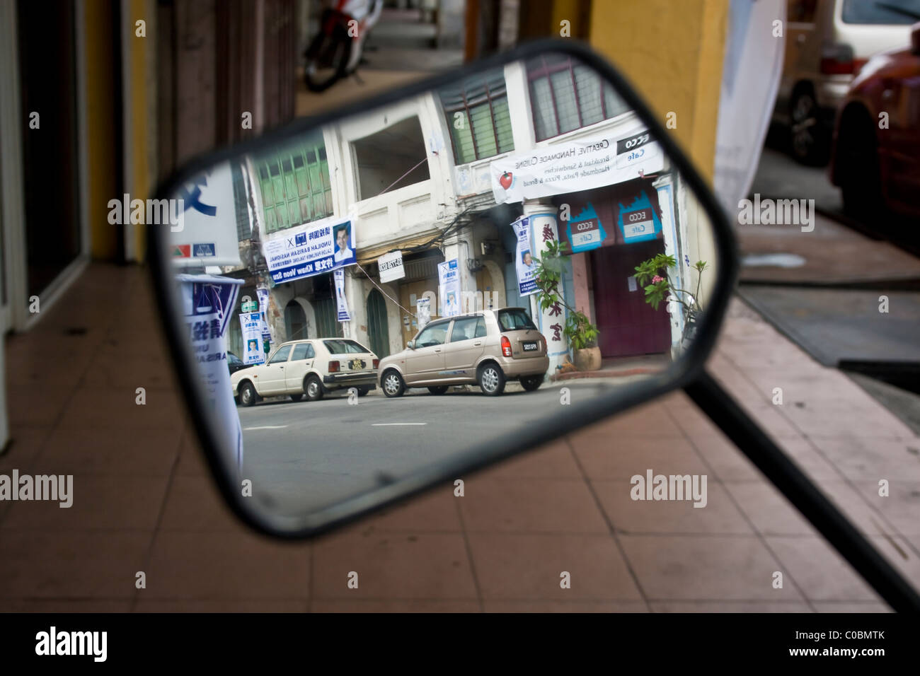 Two cars reflected in a scooter mirror in Penang, Malaysia Stock Photo ...