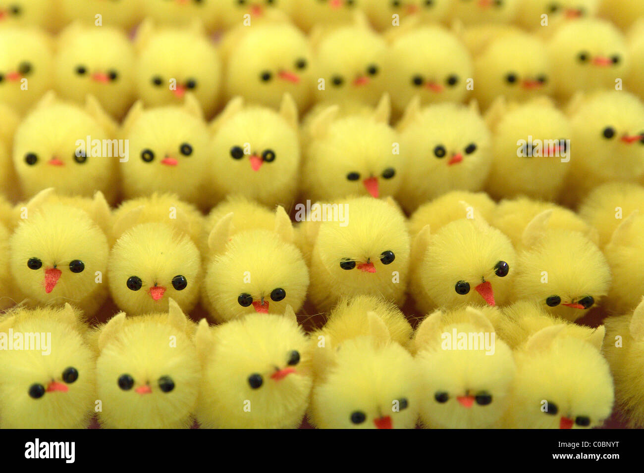 Many lines of yellow easter chicks for cake decoration Stock Photo - Alamy