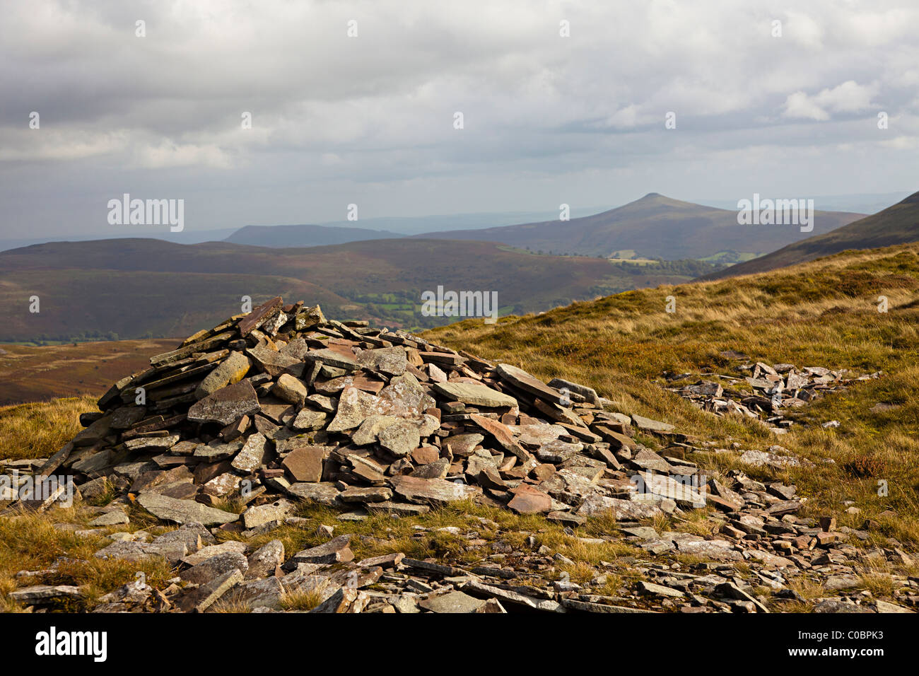 Stone cairn on Pen Alt-Mawr with the Sugar Loaf mountain in the ...