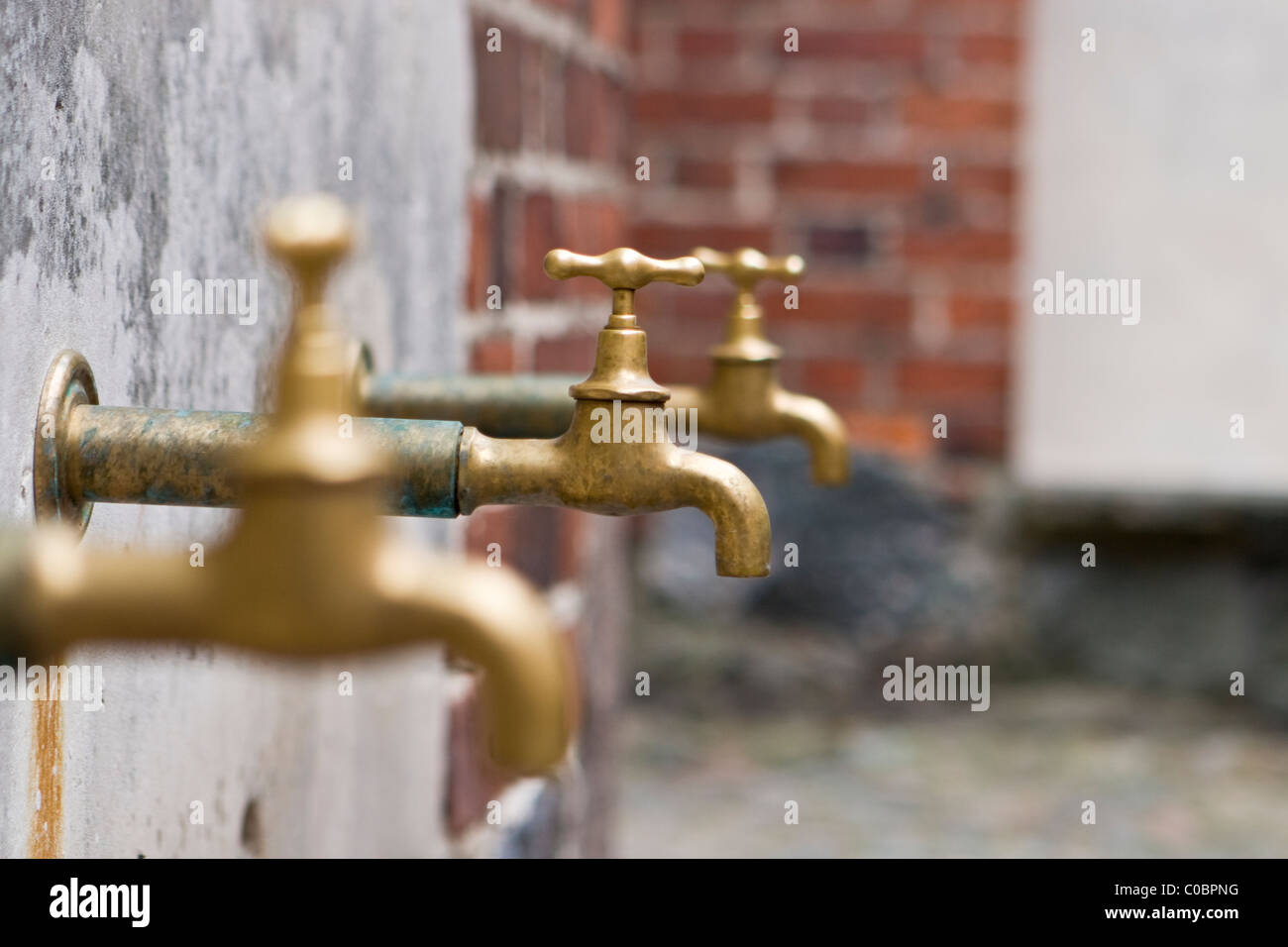 Closeup of copper taps in a row with focus on the middle tap Stock ...