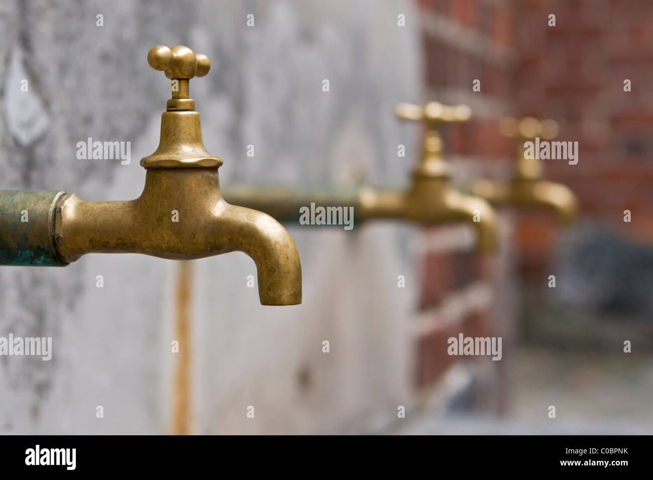 Closeup of copper taps in a row with focus on the first tap Stock Photo ...