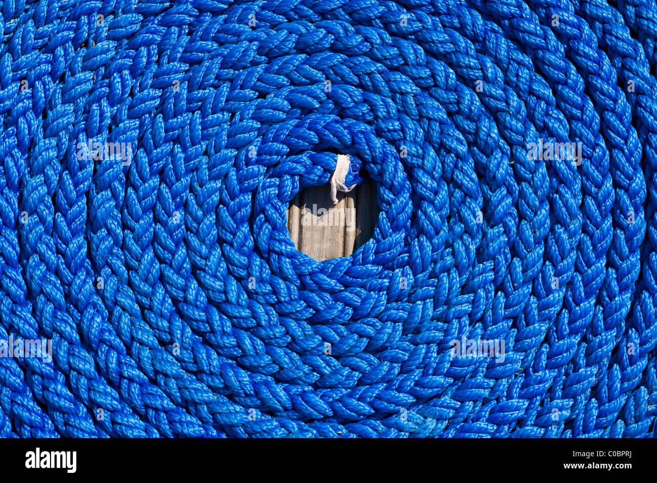 Coiled blue rope on wooden planks Stock Photo - Alamy