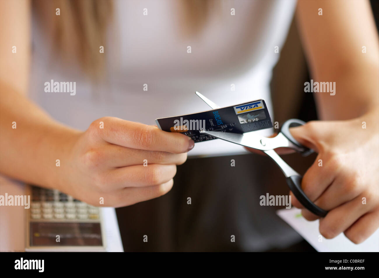 hands of female cutting a bank card in two/half Stock Photo - Alamy