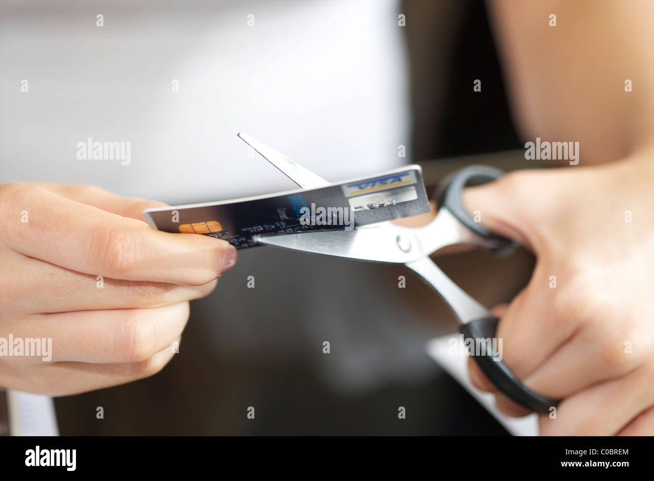 hands of female cutting a bank card in two/half Stock Photo - Alamy