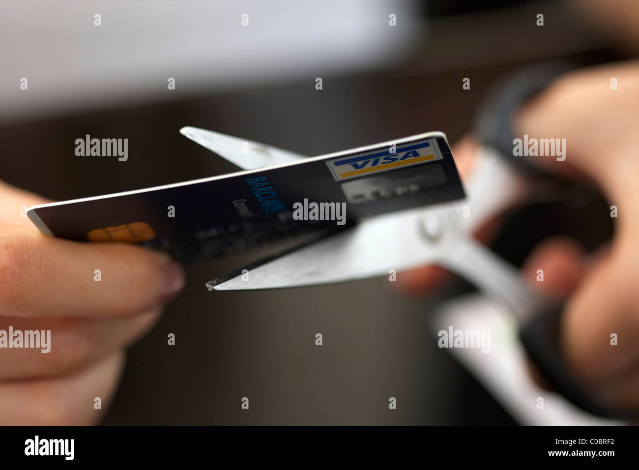 hands of female cutting a bank card in two/half Stock Photo - Alamy