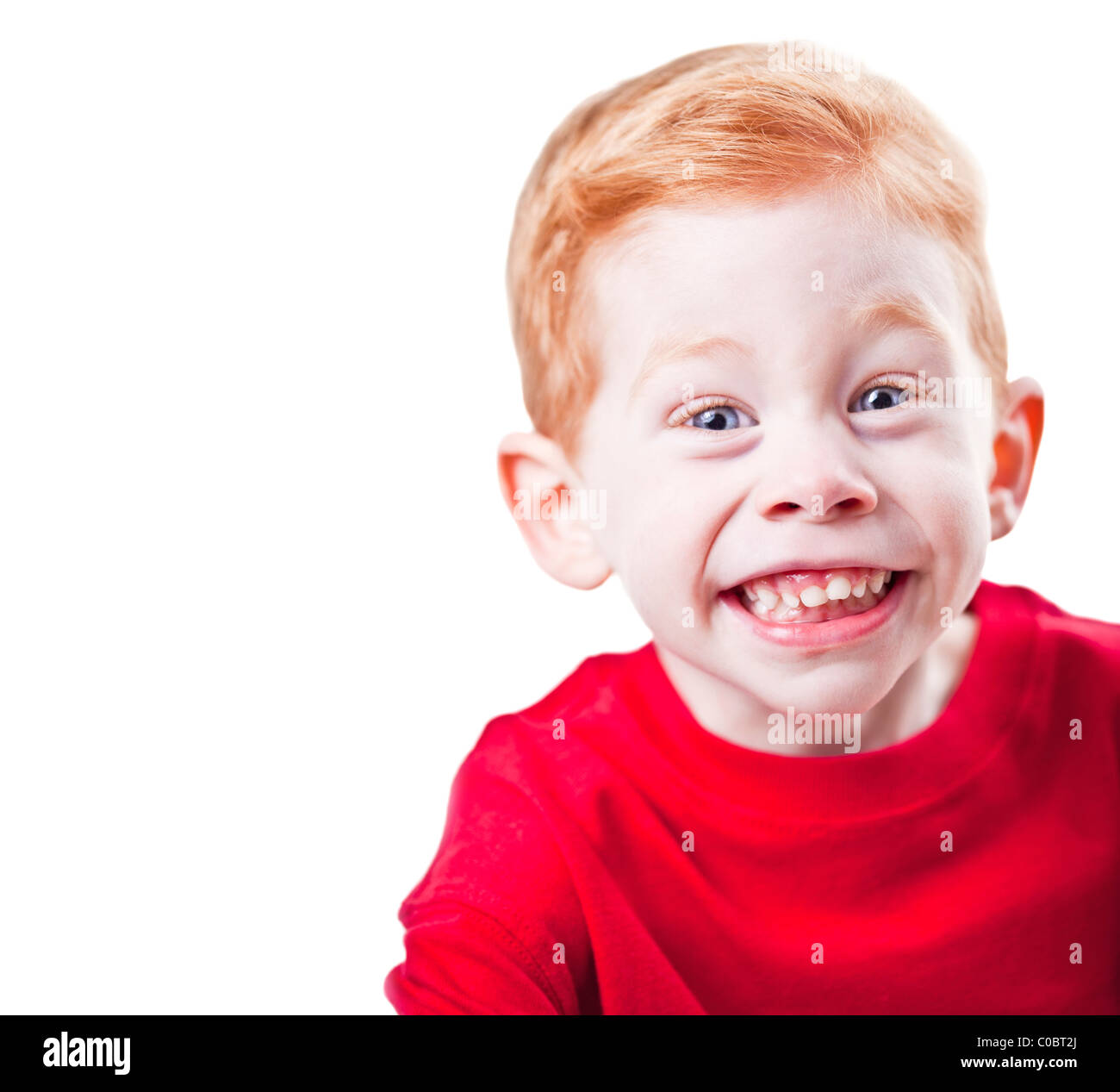 Happy redheaded boy smiling facing forwards on white background Stock ...