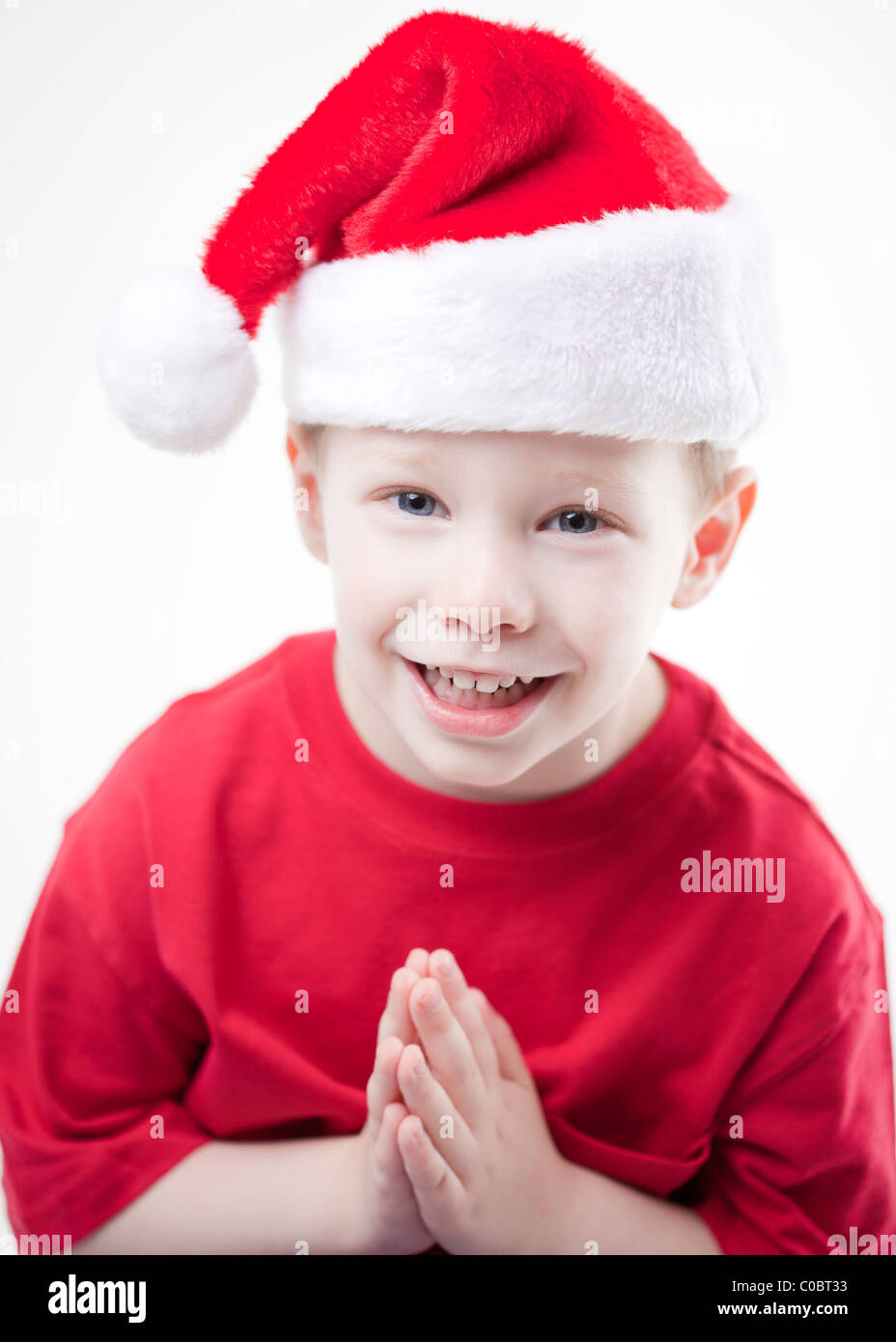 Portrait of a boy wearing a santa hat smiling hi-res stock photography ...