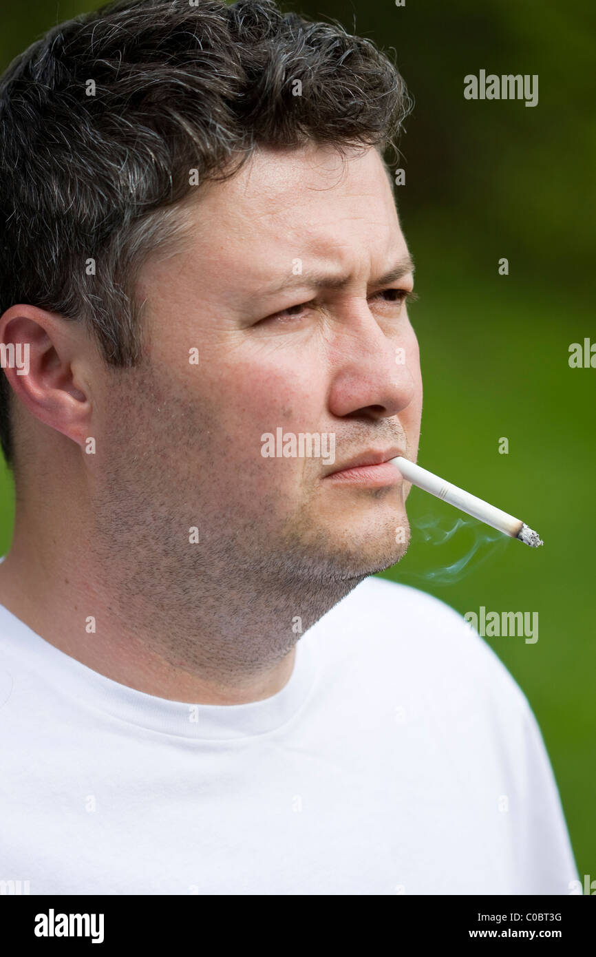 Middle eastern man smoking a cigarette Stock Photo - Alamy