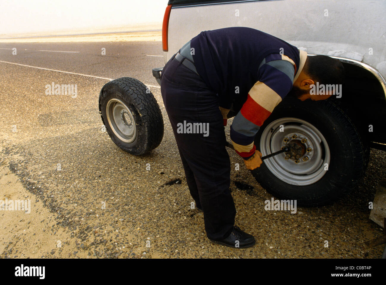 Kuwait Breakdown In The Desert Using Wheel Brace Changing Tyre Stock ...