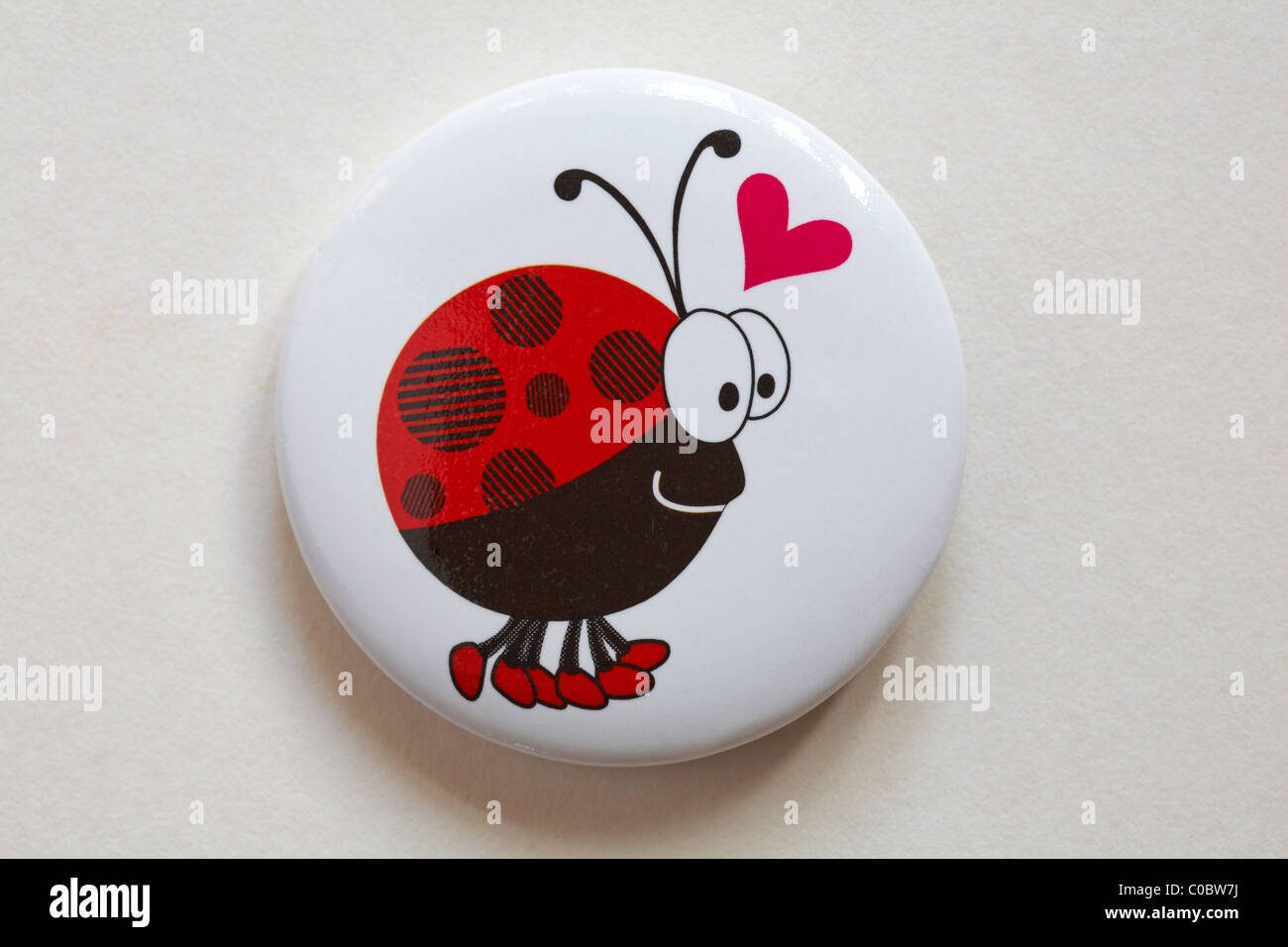 ladybird round pin badge isolated on white background Stock Photo - Alamy