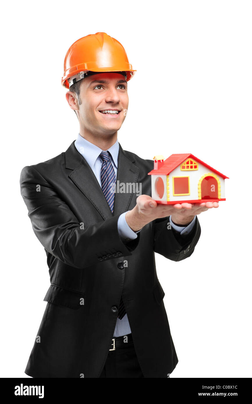A smiling foreman wearing helmet and holding a model house Stock Photo ...