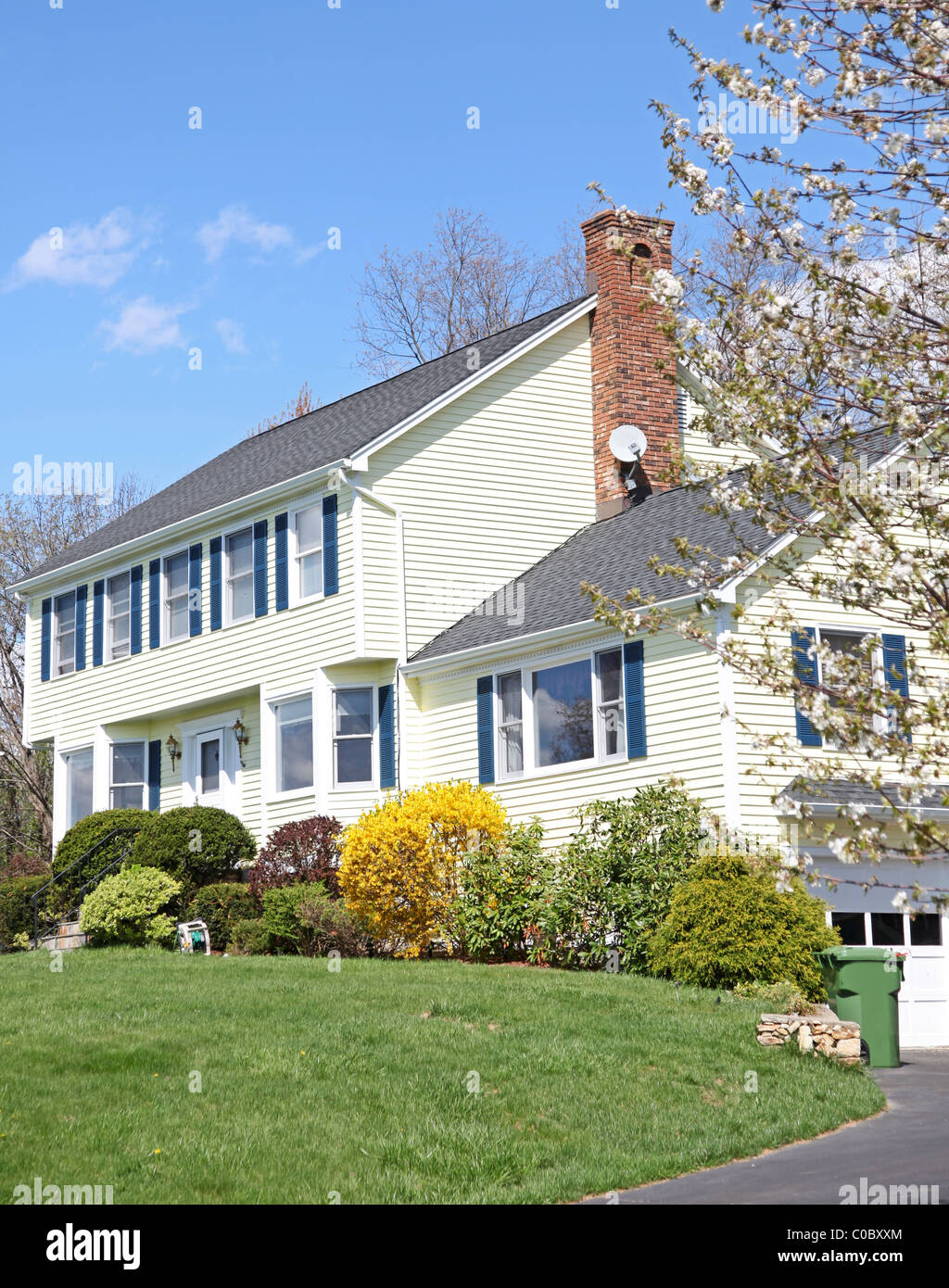 Yellow New England Style colonial house on a spring day Stock Photo - Alamy
