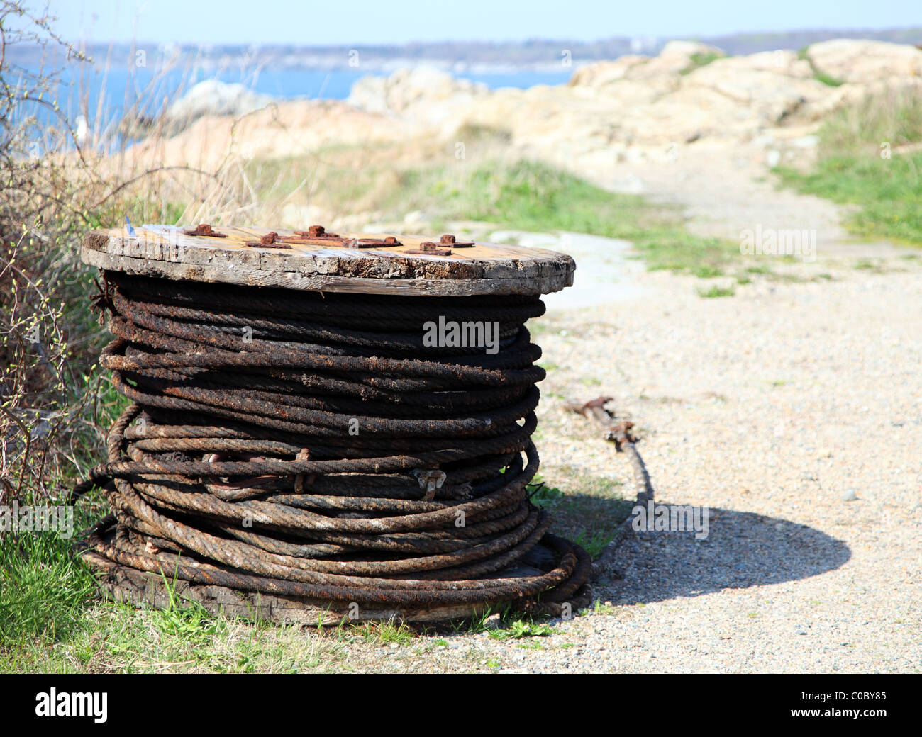 Old rusty steel shipping cable on wooden reel Stock Photo - Alamy