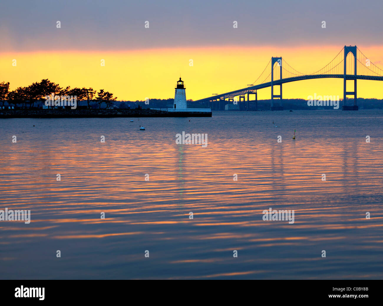 Beautiful sunset over bridge and lighthouse in Newport, Rhode Island ...