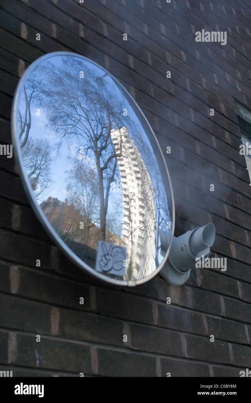 Convex mirror reflecting tall white building and trees, Paddington ...