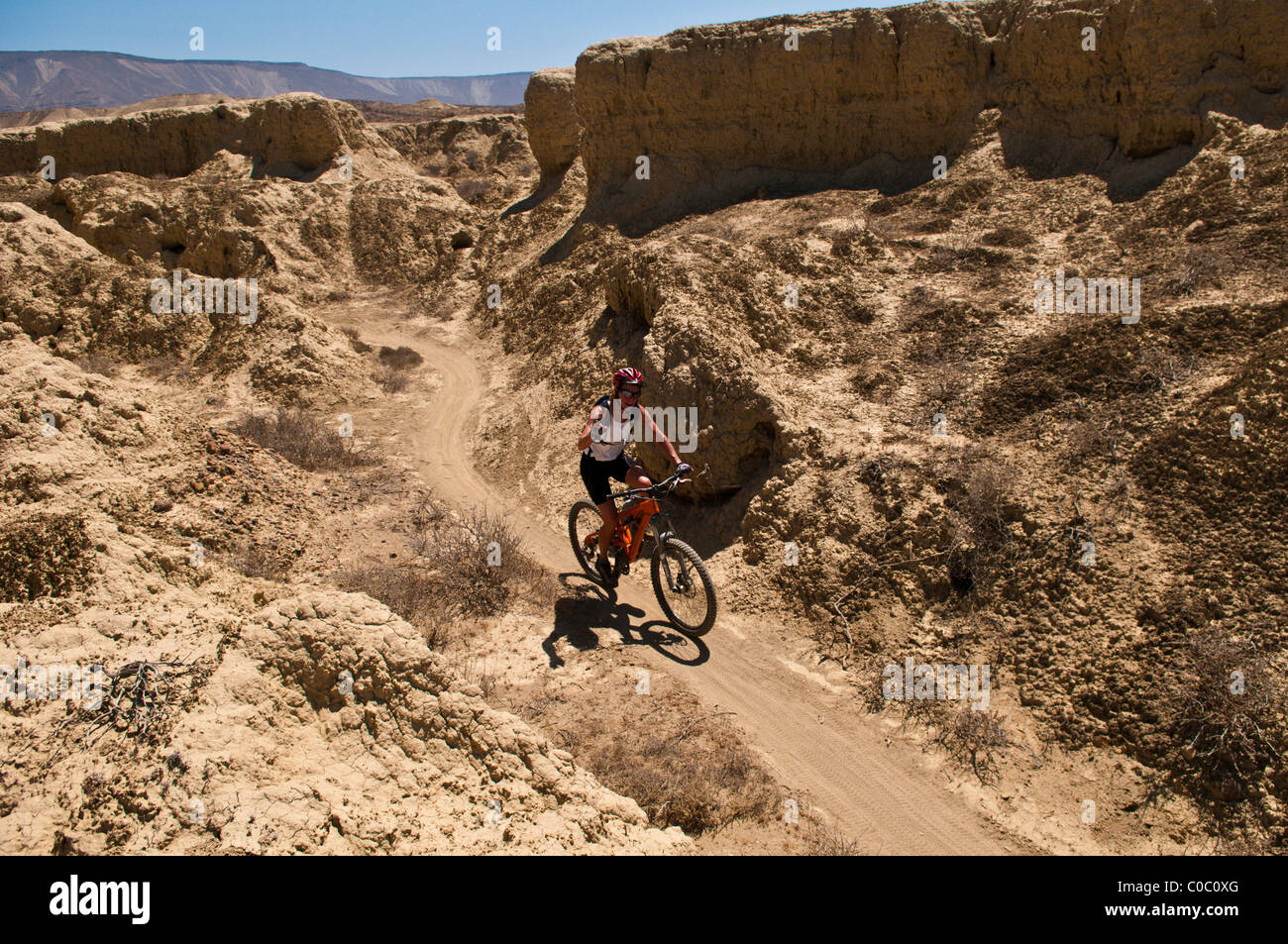Woman mountain biking in the Badlands at Punto San Carlos, Baja ...