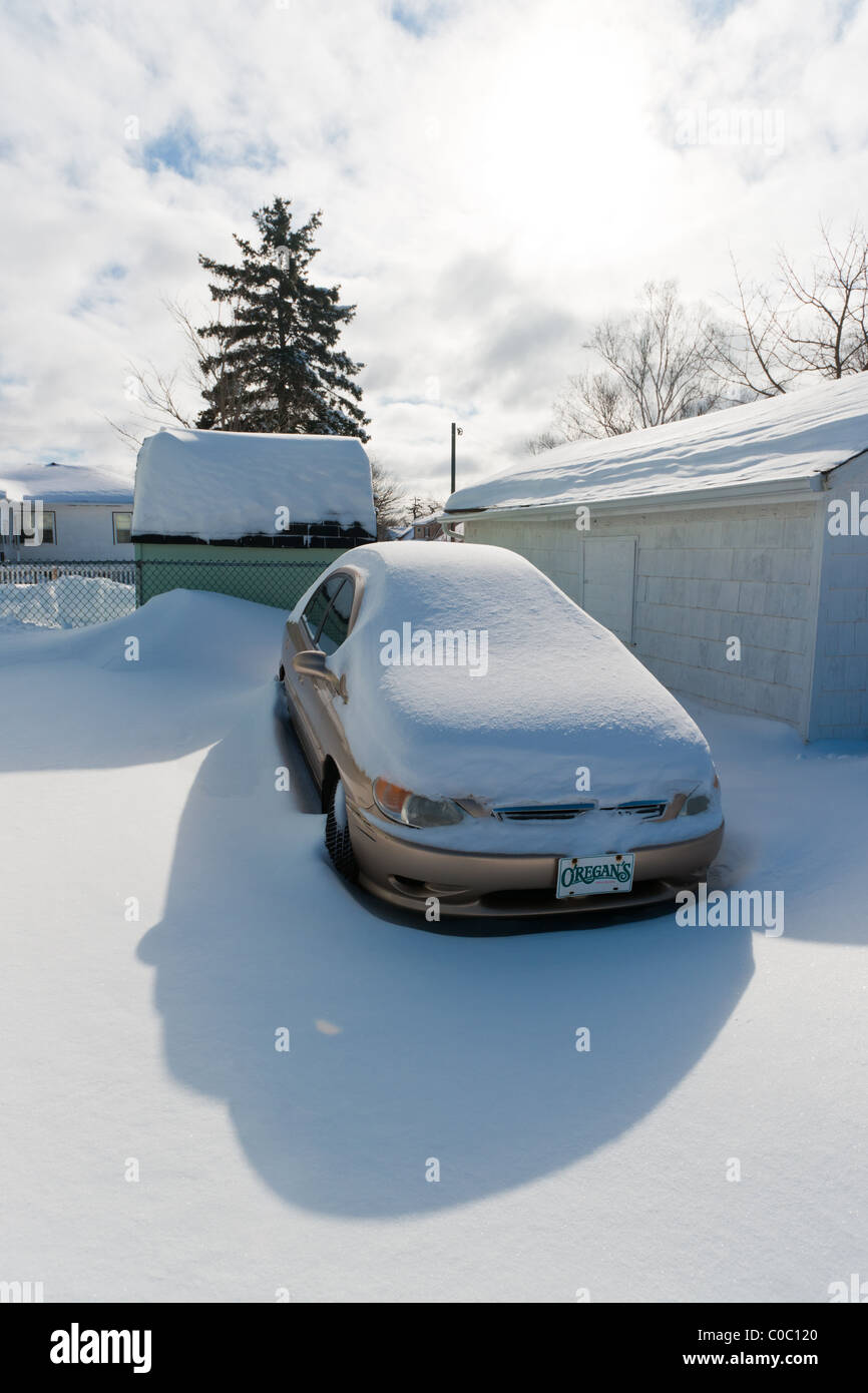 A car sits in a driveway after a snow storm Stock Photo - Alamy