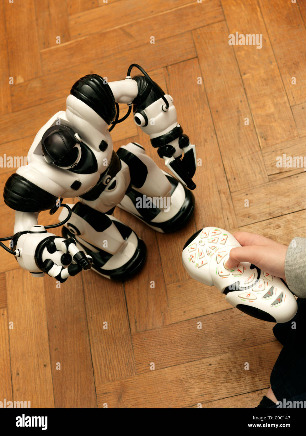 Teenager Playing With A Robot Using Remote Control Stock Photo - Alamy