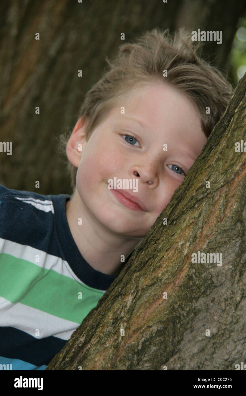 Portrait of smiling boy in tree Stock Photo - Alamy