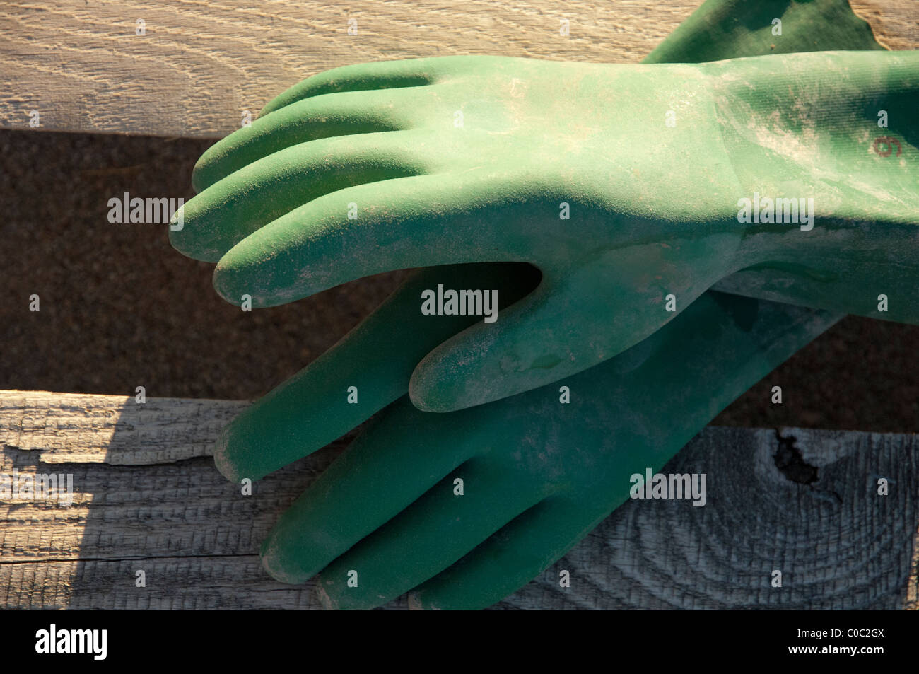 Green rubber work gloves Stock Photo - Alamy