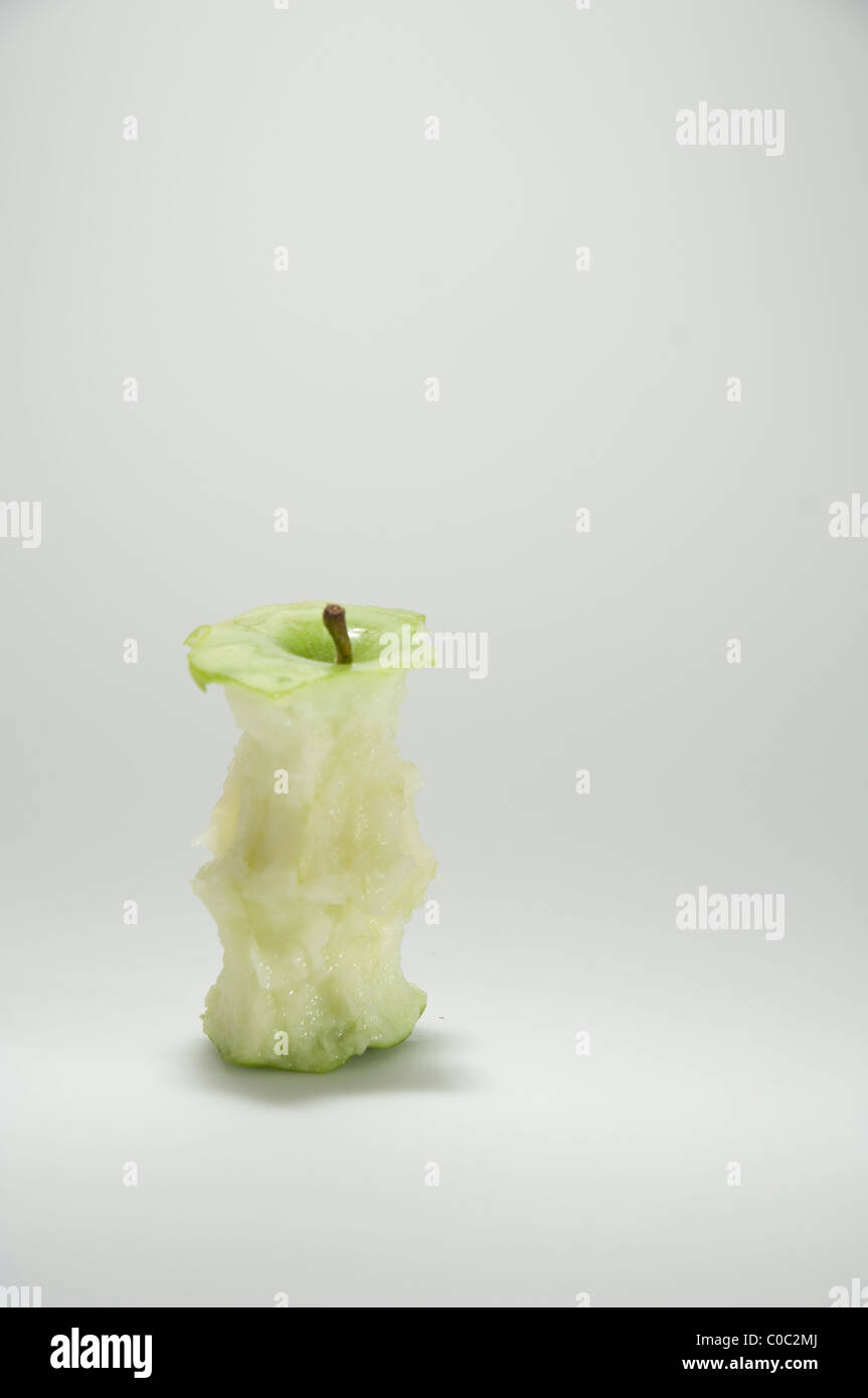 Core of an eaten green apple Stock Photo - Alamy