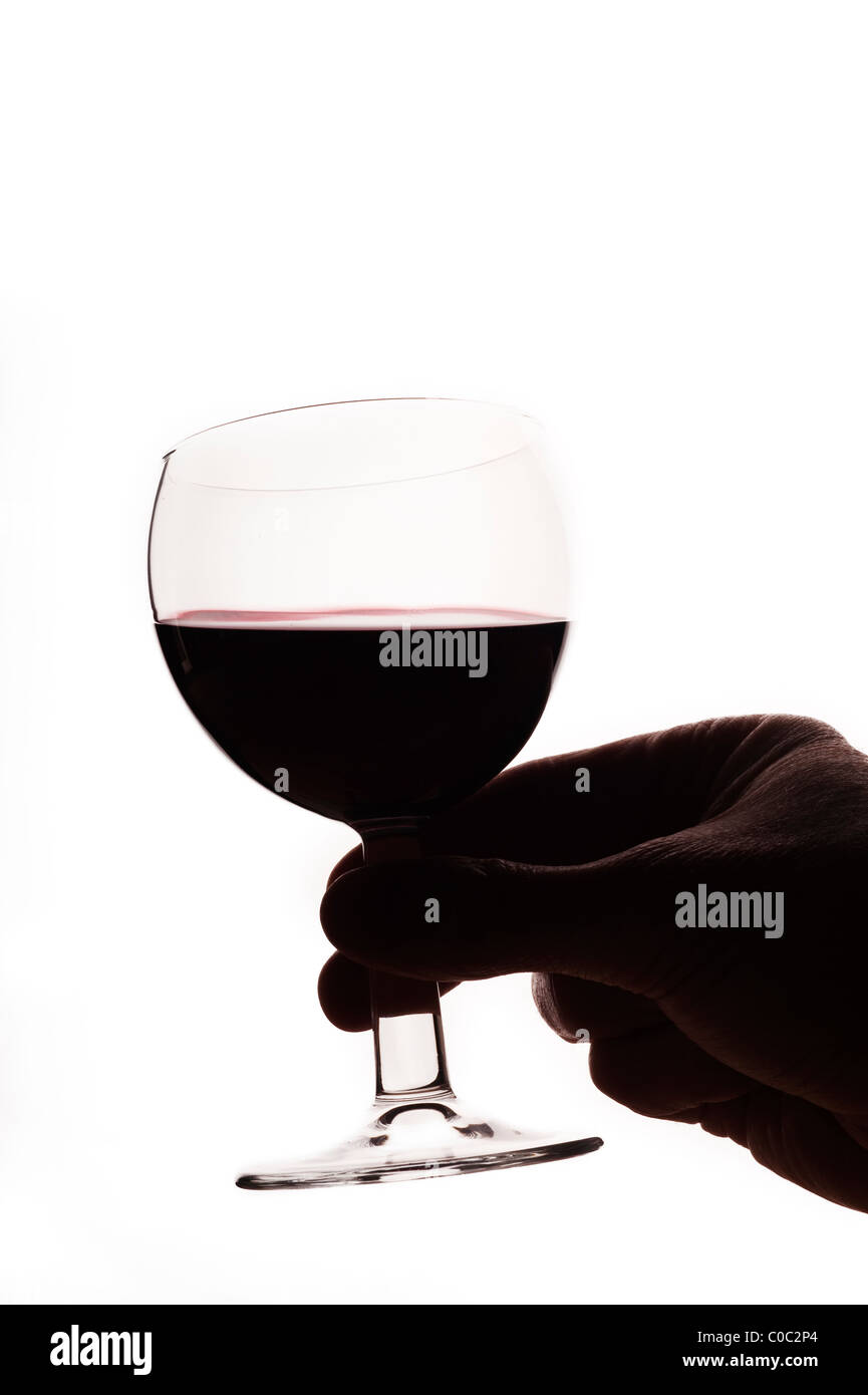 Hand holding a glass of red wine on a white background Stock Photo - Alamy