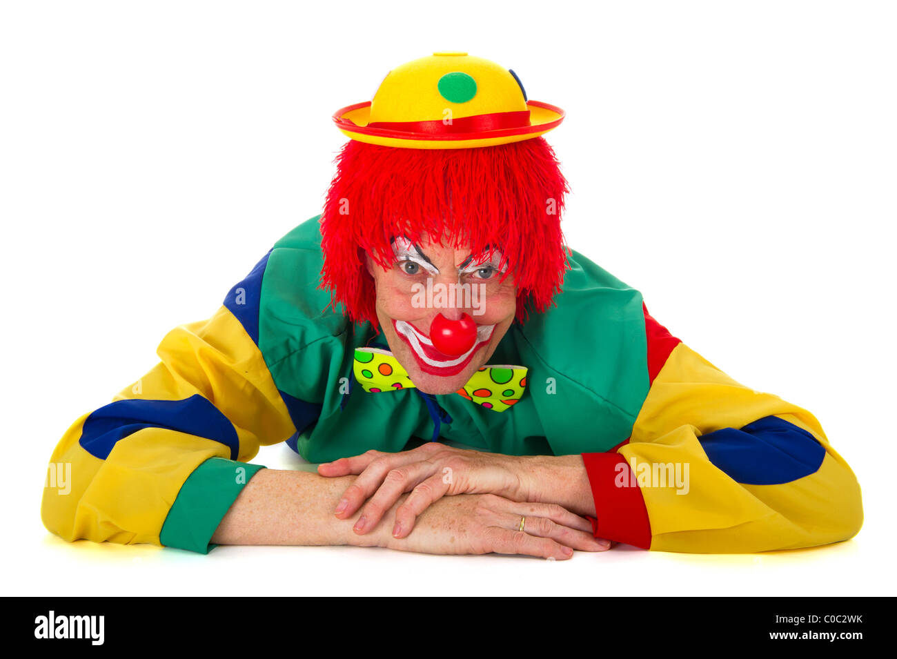Funny clown laying at the floor on white background Stock Photo - Alamy