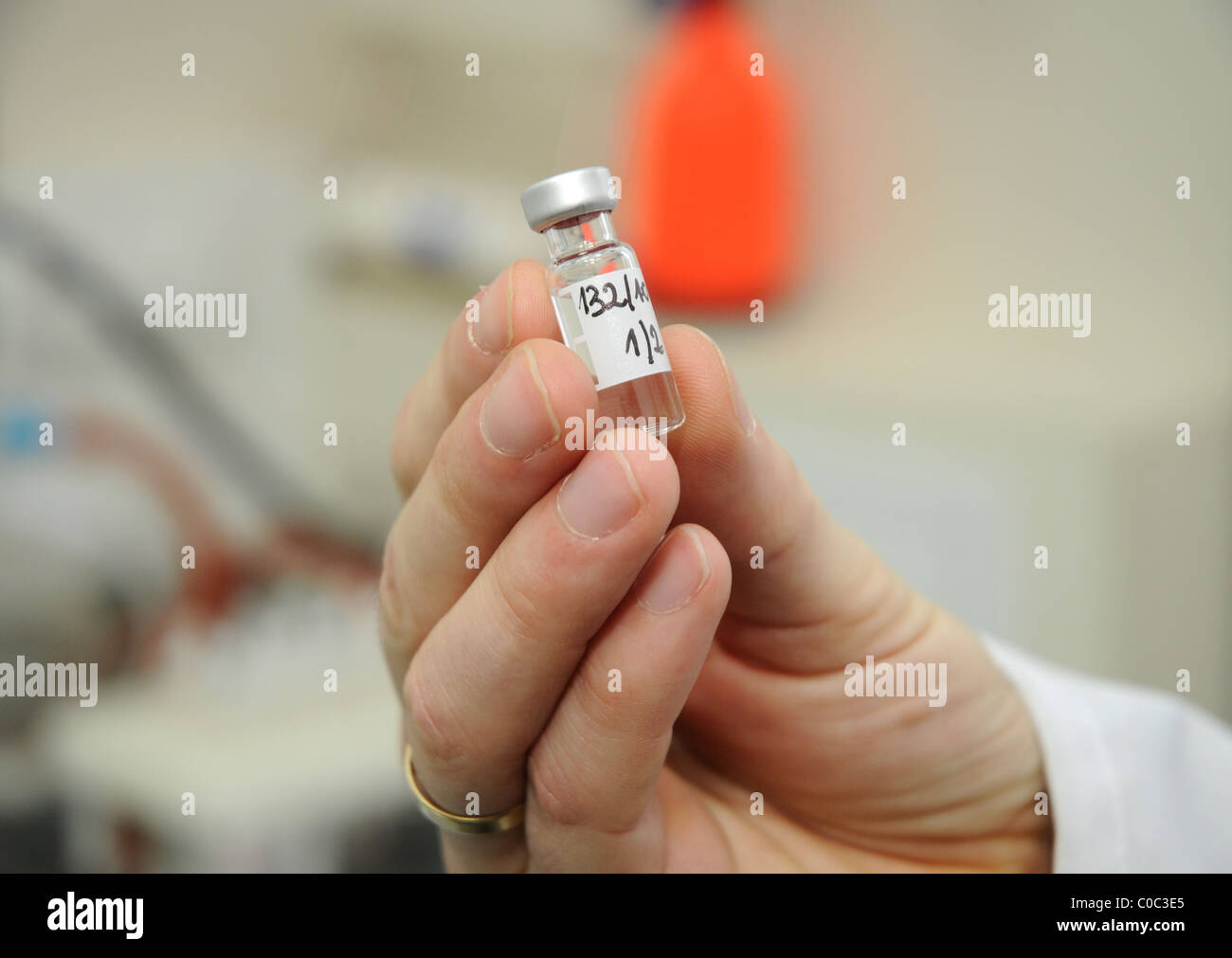 lab assistant showing a small sample vial in Central Forensic ...