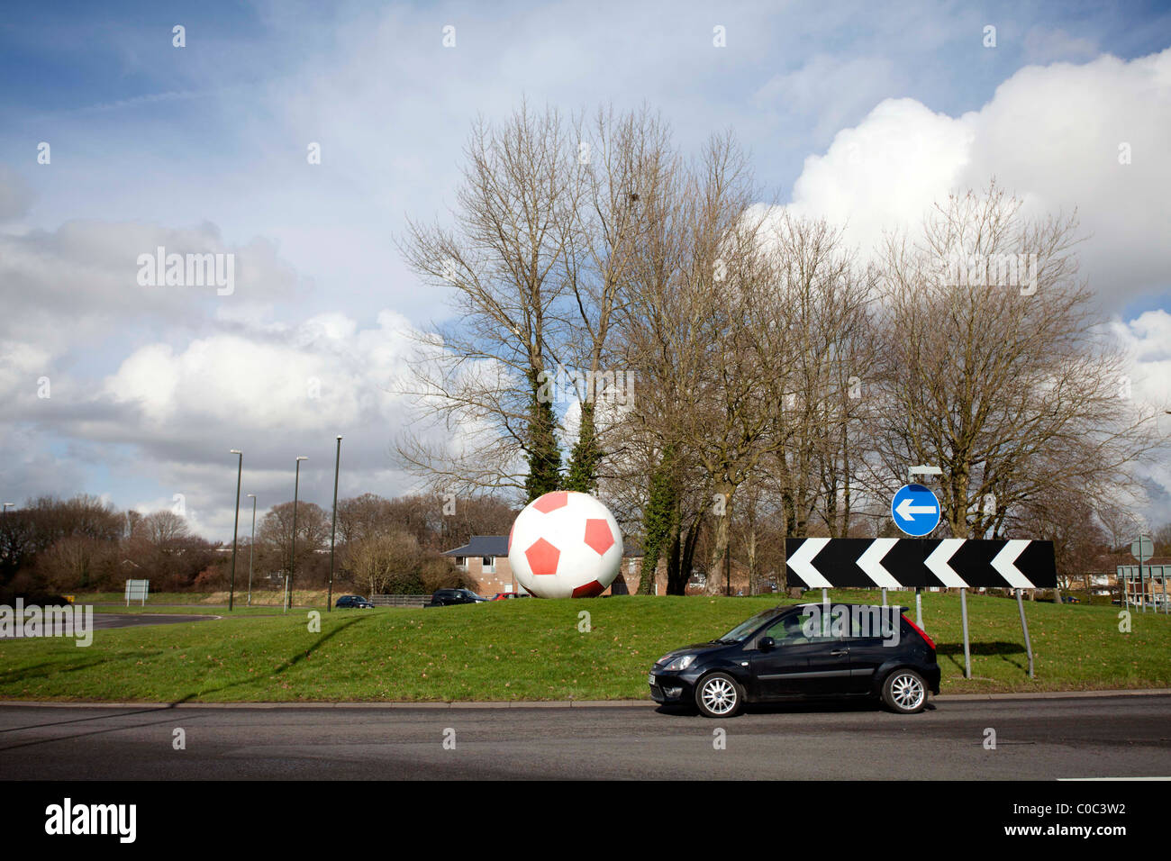 A giant football on a traffic roundabout in Crawley, West Sussex ...