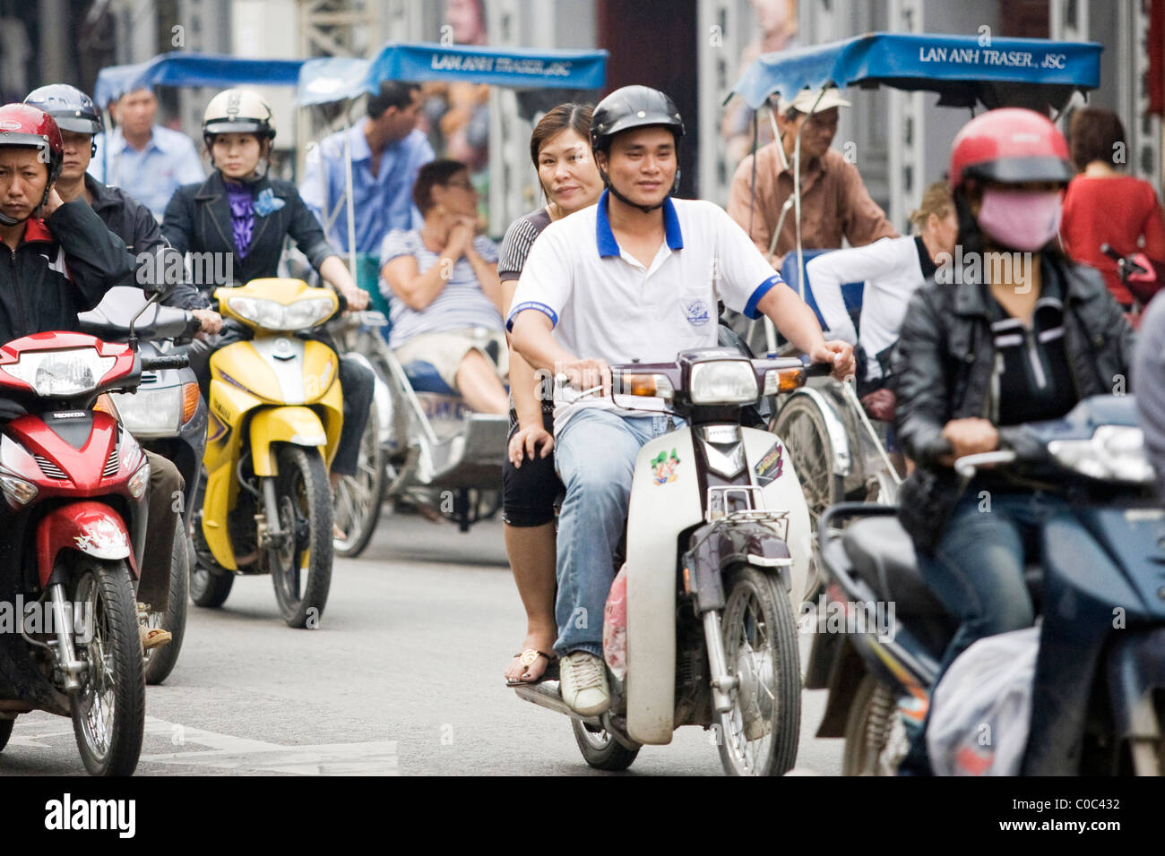 People riding scooters/mopeds in Vietnam in Hanoi Stock Photo - Alamy