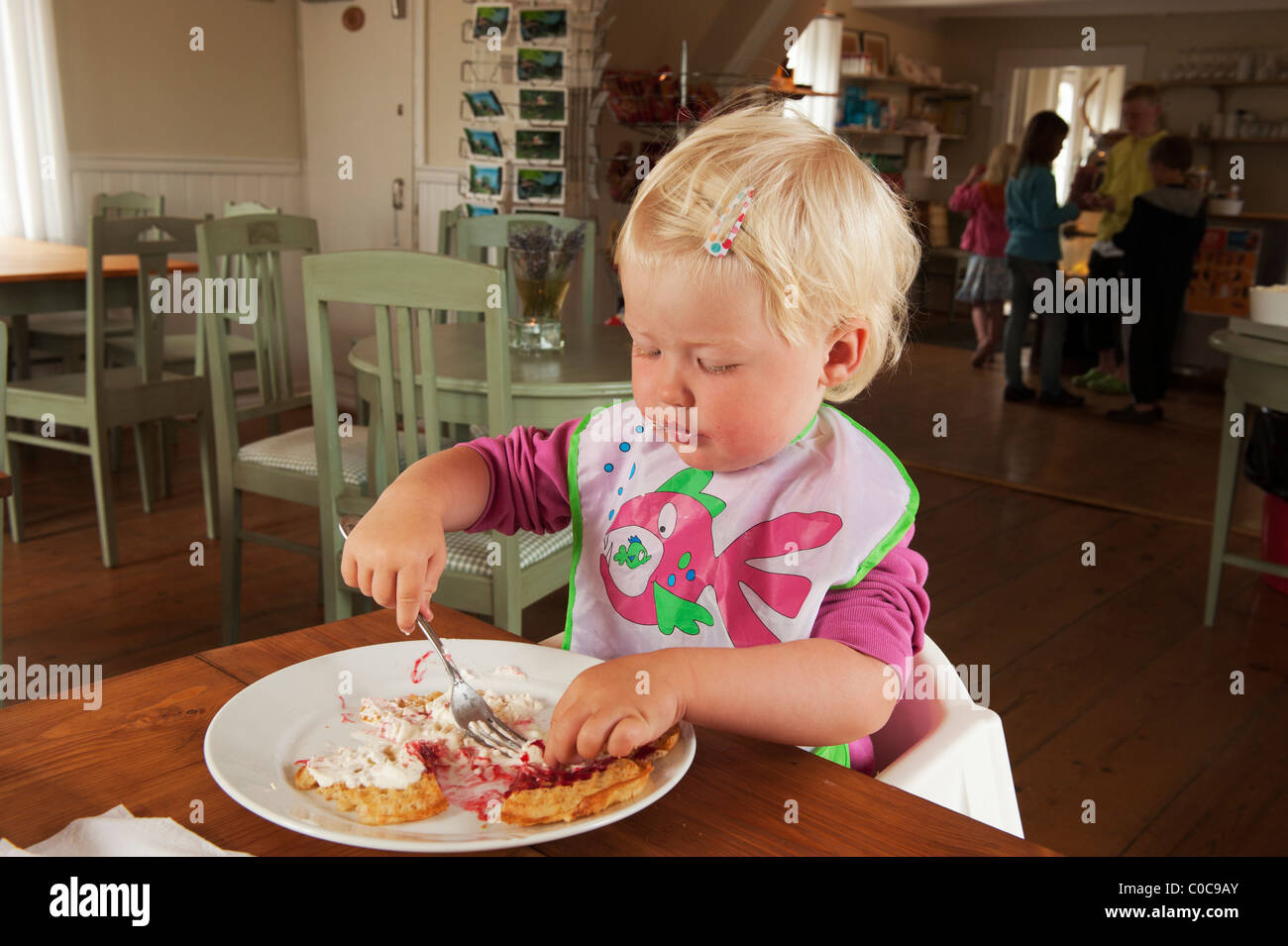Baby girl eating Stock Photo - Alamy