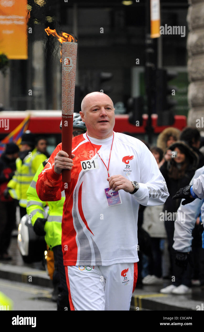 Clive Woodward holds the torch at The Beijing 2008 Olympic Games torch ...