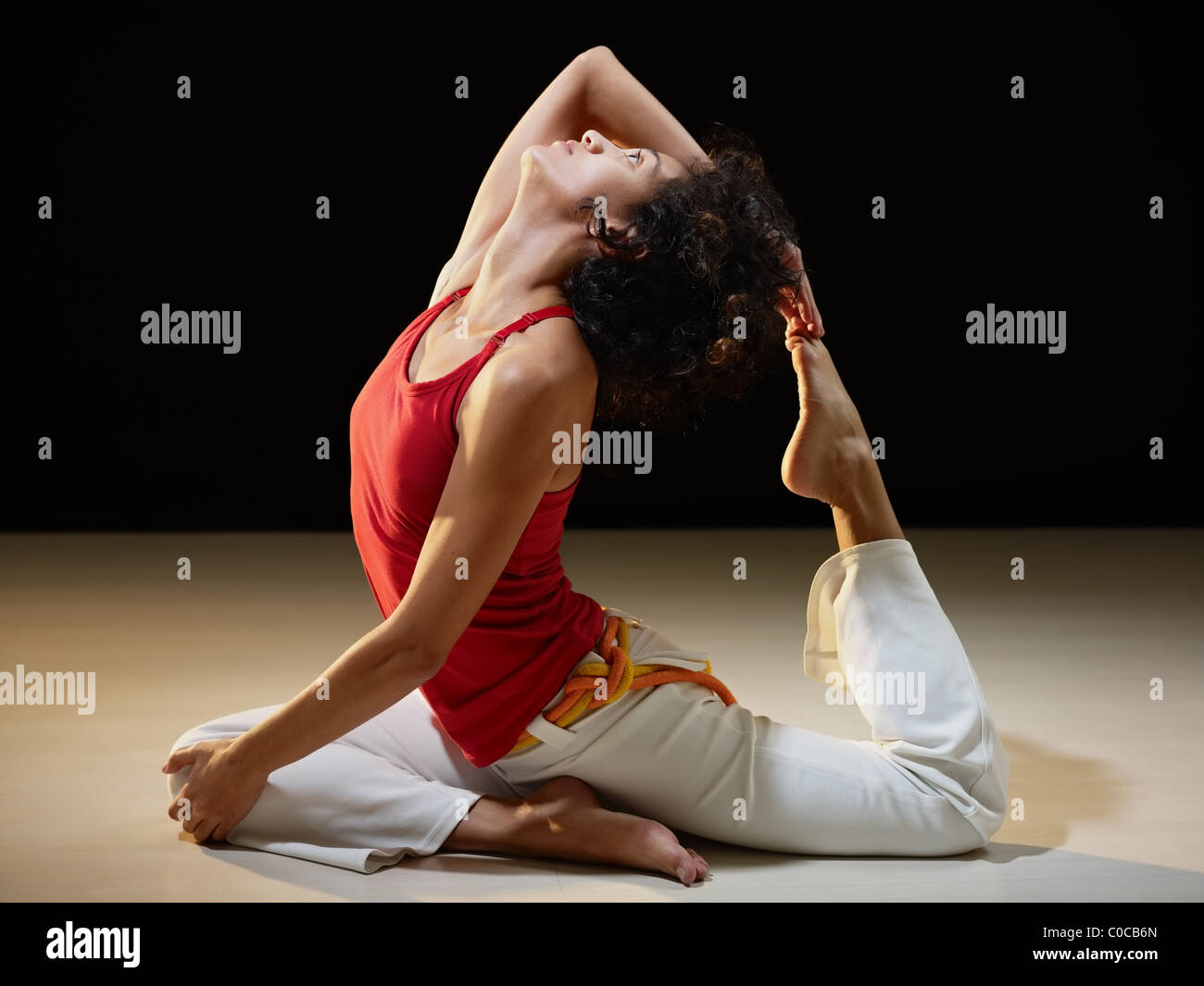 portrait of young adult latin american female doing yoga exercise in ...