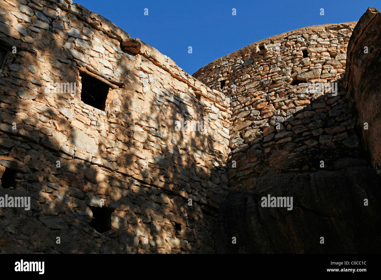 The thick stone walls of buildings in the Omani mountain village of ...