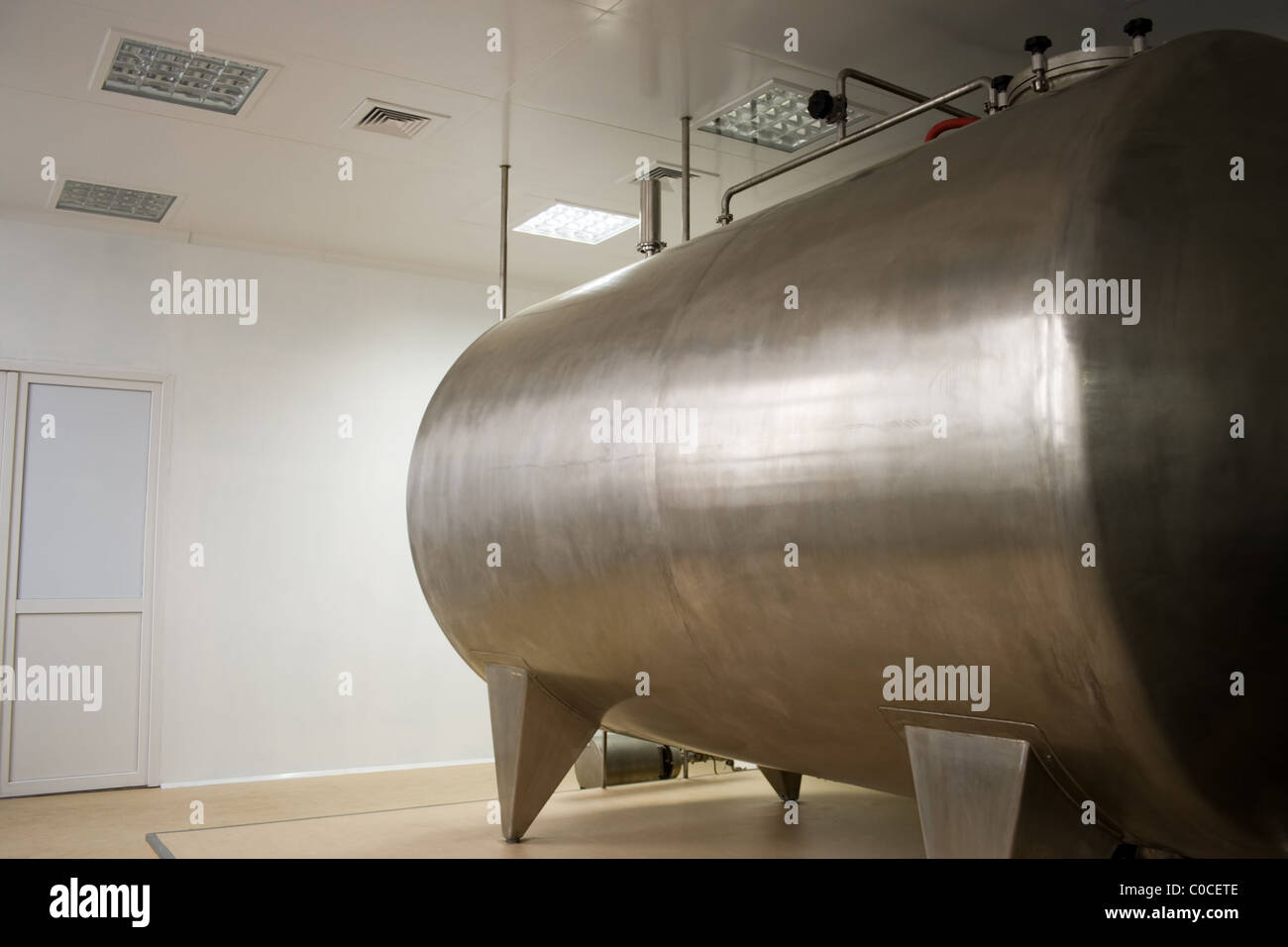Placing plant medicines, large stainless tank Stock Photo - Alamy