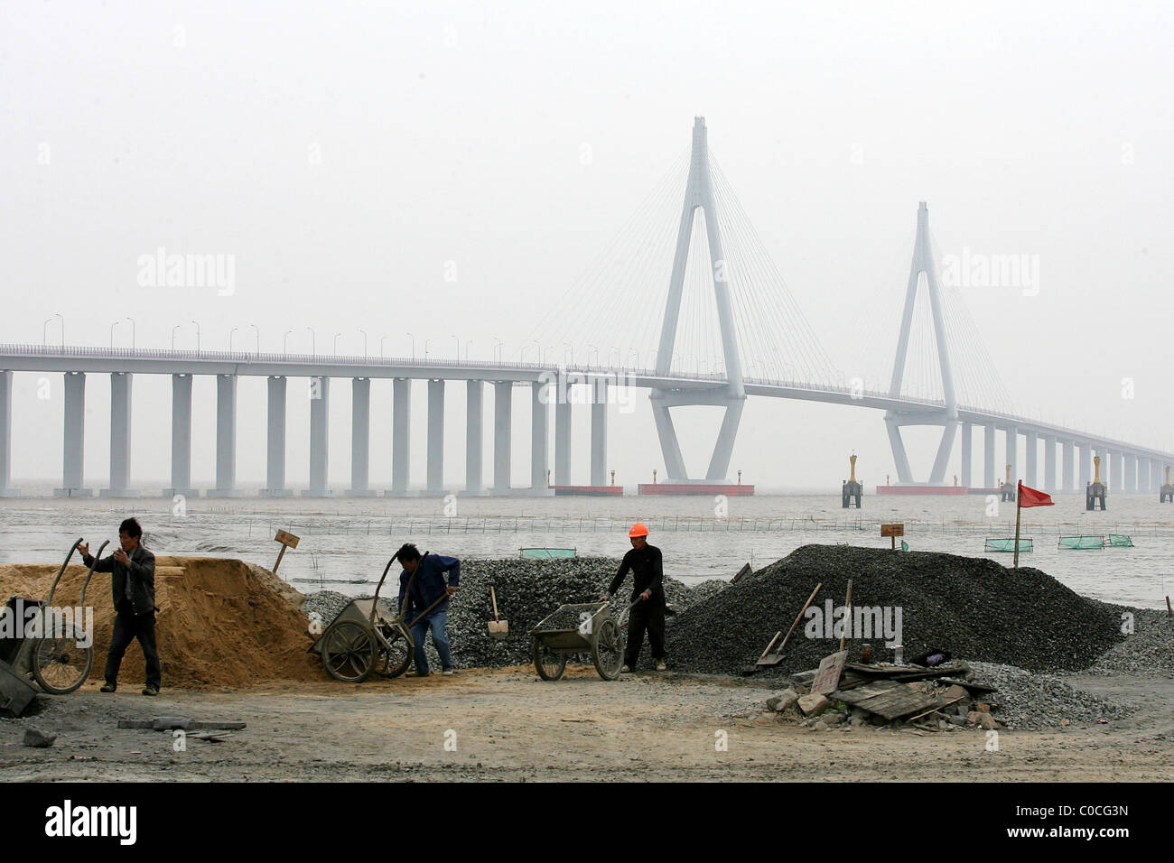 WORLD'S BIGGEST BRIDGE NEARS COMPLETION Workers put the finishing ...