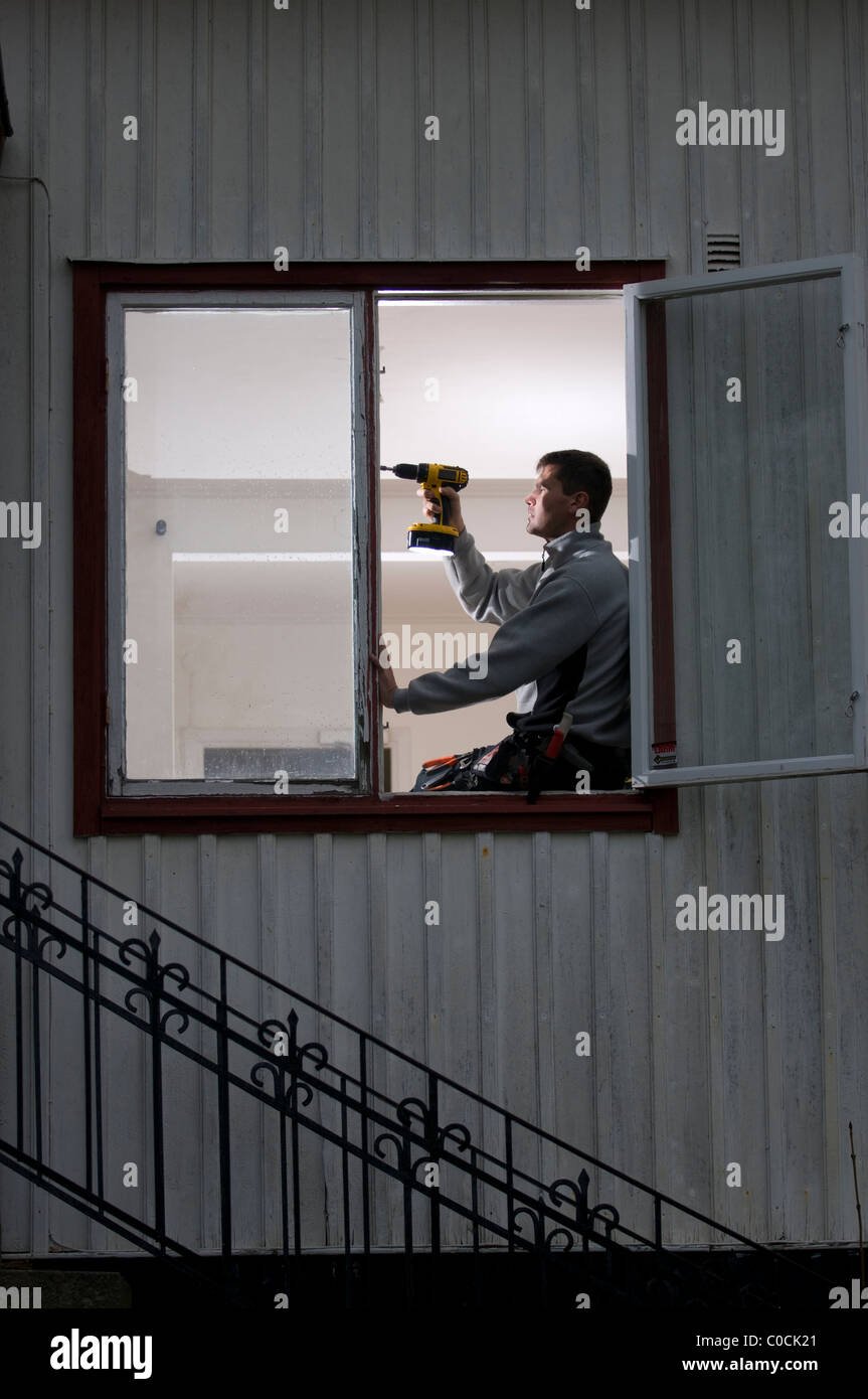 Man doing home improvement using power drill Stock Photo - Alamy