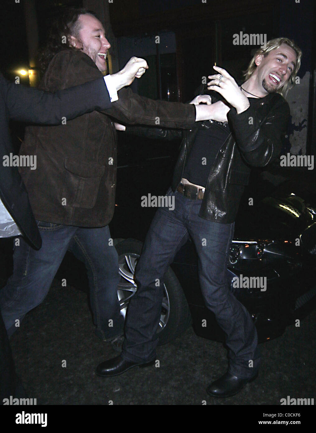 Chad Kroeger of Nickelback play fights with a friend outside Boujis and ...