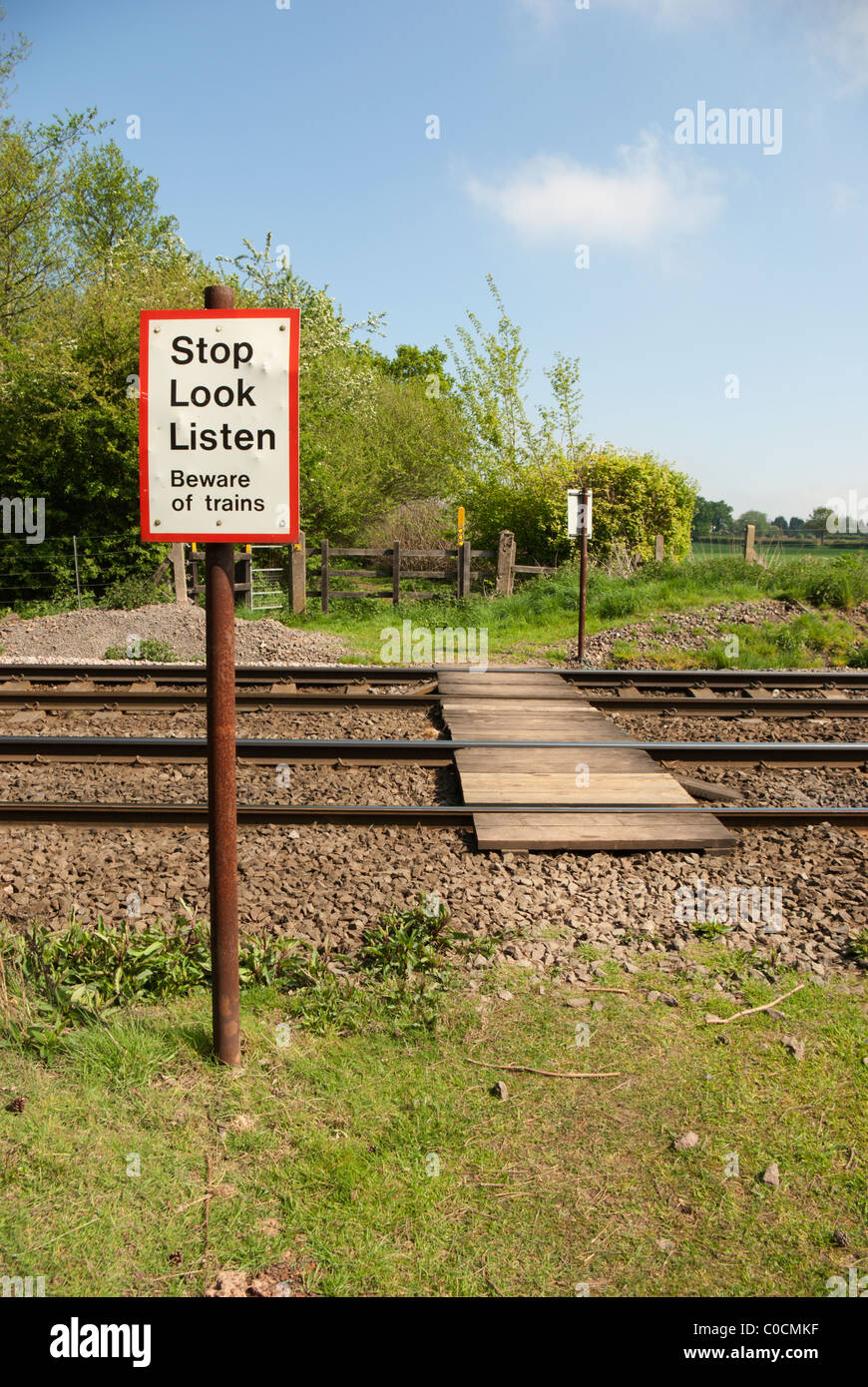 Unmanned pedestrian level crossing and warning sign Stock Photo - Alamy