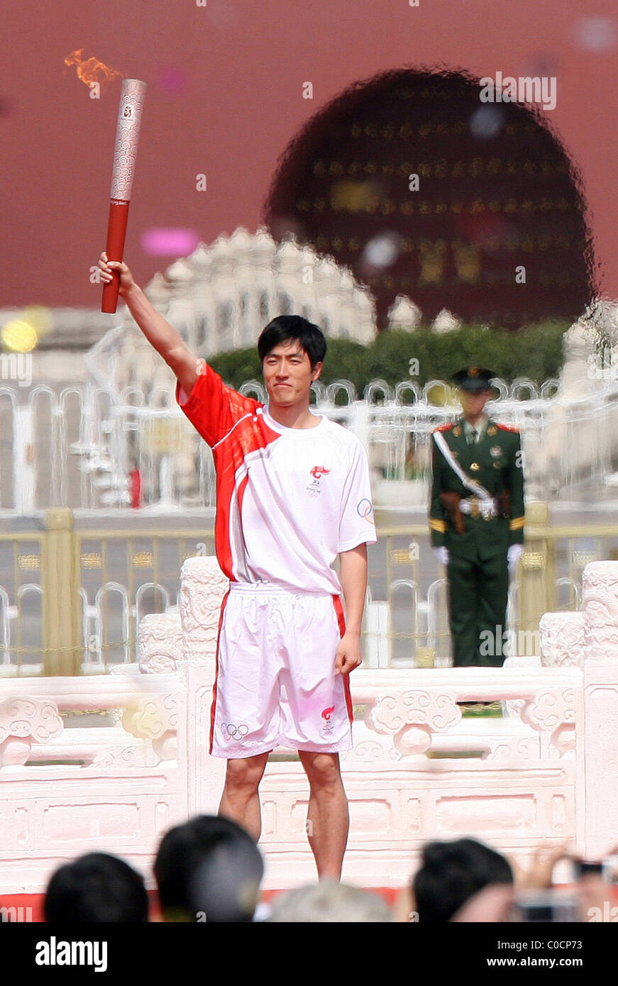 China`s 110m hurdles record-holder Liu Xiang holds the Olympic torch ...